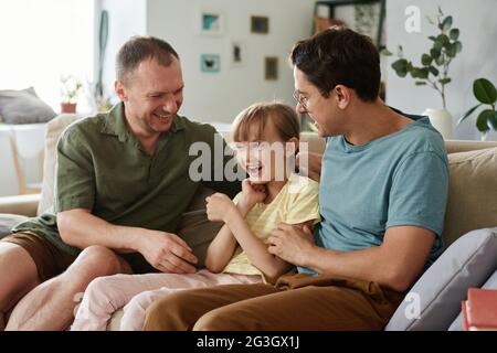 Parent and child having fun together playing a claw machine game in an ...