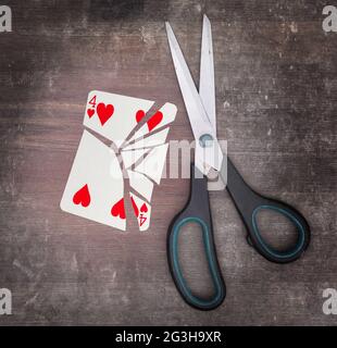 Concept of addiction, card with scissors, four of diamond Stock Photo ...