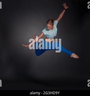 Beautiful woman jumping in the splits Stock Photo - Alamy