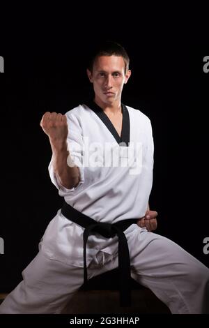 Karate, master and martial arts portrait of man in studio, black ...