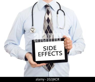 Doctor holding tablet - Side effects Stock Photo - Alamy