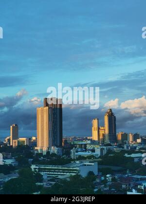 Vertical shot of skyscrapers under a blue cloudy sky Stock Photo - Alamy