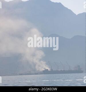A ship being loaded with sand from nearby quarry, Khasab, Oman Stock ...