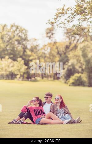 Best friends resting in park Stock Photo - Alamy
