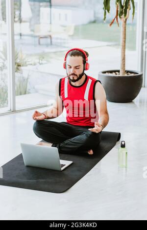 Latin American male yogi sitting practicing Nauli Kriya with Limgan ...