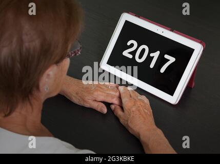 Senior lady relaxing and her tablet - New year - 2019 Stock Photo - Alamy