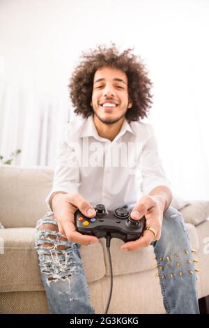 Male student playing computer games at home Stock Photo - Alamy