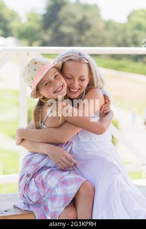 Mom and daughter hugging and laughing Stock Photo - Alamy