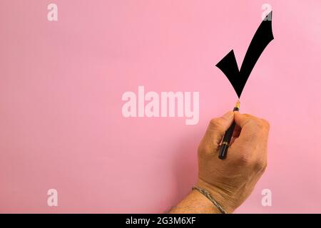 hand holding a pen writing an OK sign on a pink background Stock Photo ...