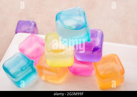 Fake colorful ice cubes on a brown background Stock Photo - Alamy