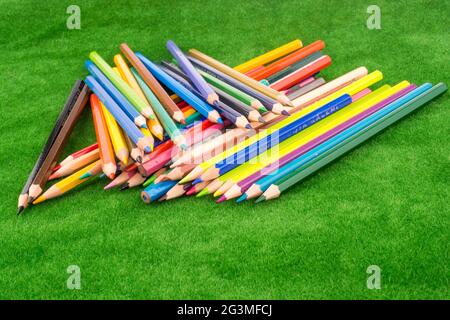 Color pencils scattered on green grass Stock Photo - Alamy