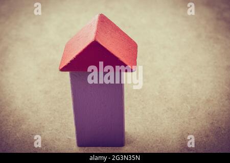 House shape formed out of building blocks on a brown background Stock ...