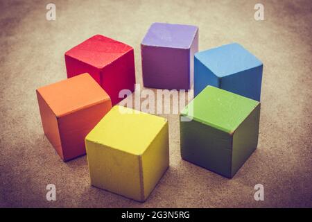 Colorful building blocks on a brown background Stock Photo - Alamy