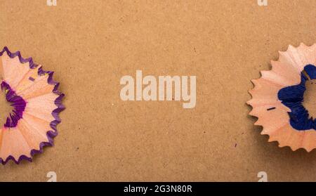 Colorful pencil shavings on a brown background Stock Photo - Alamy