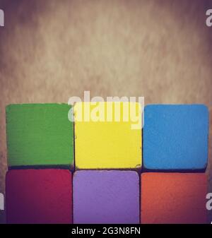 Colorful building blocks on a brown background Stock Photo - Alamy