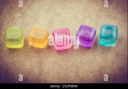 Fake colorful ice cubes on wood Stock Photo - Alamy
