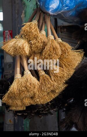 Set of yellow straw broom in a bazaar Stock Photo - Alamy