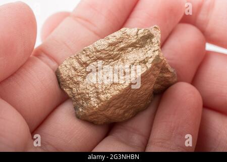 Little gold color stone on with a background Stock Photo - Alamy