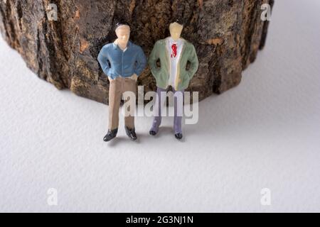 Tiny figurine of man miniature in green sand texture Stock Photo - Alamy