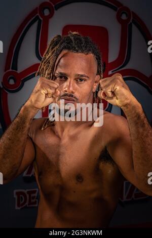 Vertical shot of a martial arts master with dreads posing in a dojo ...