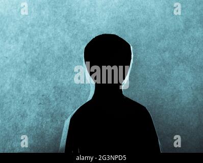 Man shape cut out of paper in notebbok in hand Stock Photo - Alamy