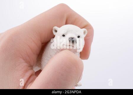 Hand holding a Polar bear model on a wooden background Stock Photo - Alamy