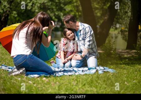 Happy family enjoying time in summer park Stock Photo - Alamy