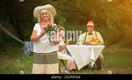 Hand holding a rose in the rose garden Stock Photo - Alamy