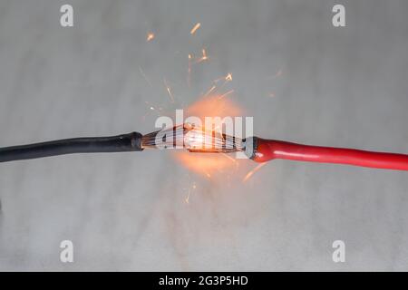 Short circuit of electrical wires sparks molten wires, fire from ...