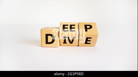 Deep dive symbol. Turned a wooden cube with words 'Deep dive ...