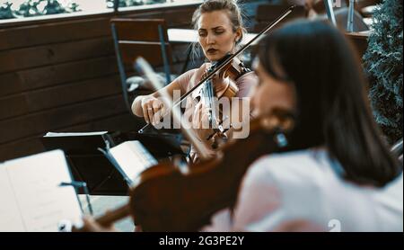 String Orchestra Female Playing Outside The Terrace Stock Photo - Alamy