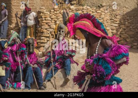 Dogon dancers performing the Dama ritual dance wearing Kanaga masks ...