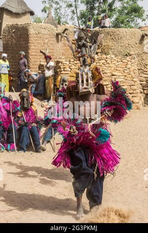 Dogon dancers performing the Dama ritual dance wearing Kanaga masks ...