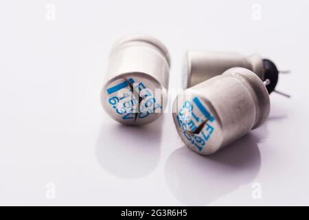 Damaged cracked electrolytic bloated exploded capacitor on white ...