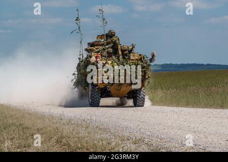 British Army Supacat HMT 400, 4x4 in high speed action over a dusty ...