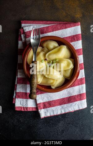 Traditional ukrainian dish vareniki served in a bowl with sour cream ...