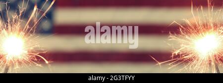 Lit sparkler burning in front of American Flag Stock Photo - Alamy