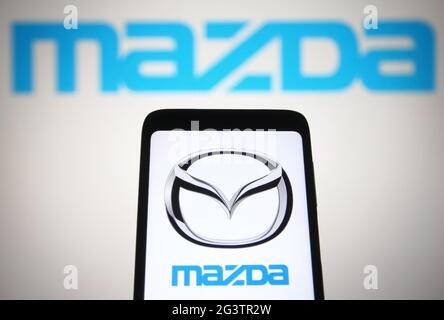 In this photo illustration, Mazda Motor Corporation logo is seen on a ...