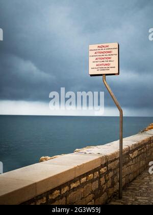 Dangerous cliffs sign in red writing and a flat marble slab Stock Photo ...