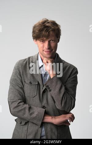 young caucasian handsome man, leaned on a bar, talking to attractive ...