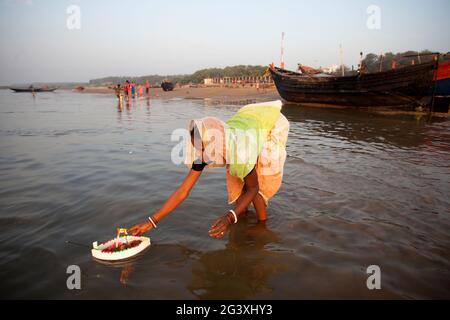 Devotee sailing model boat in the sea on the occasion of 'Boitha ...