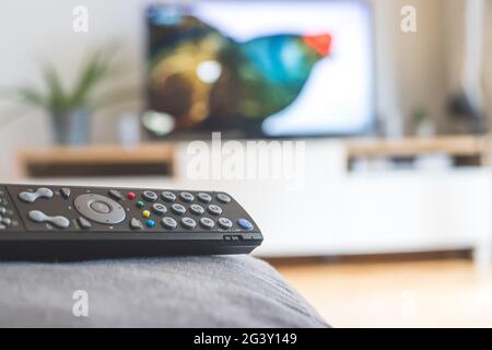 Remote control on the sofa, streaming on a smart TV Stock Photo - Alamy