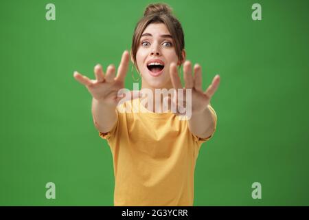 Excited and addicted goog-looking young woman reaching hands forward to ...