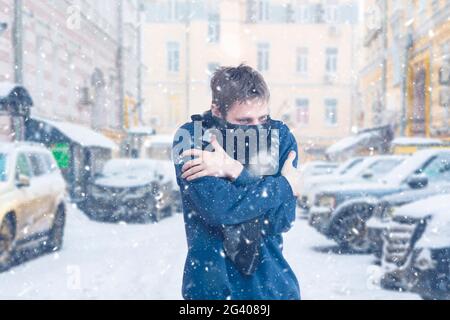 male person feeling sick, freezing cold outside, winter snowy weather ...