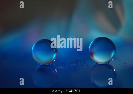Big water drops, 3d balls on a blurry background with light effects and ...