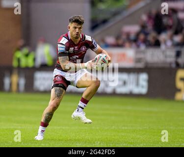 Oliver Gildart of Hull KR runs forward as Tom Briscoe of Hull FC and ...
