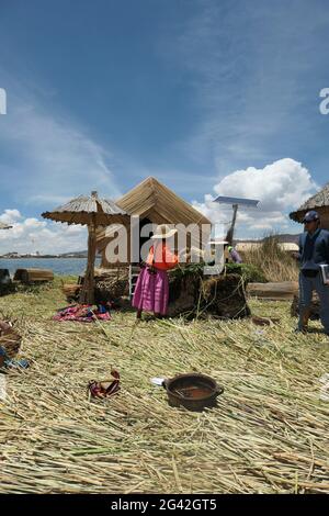 Locals showing how to make a reed or straw island in Lake Titicaca Peru ...