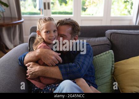 Caucasian girl and her grandfather spending time together at home ...