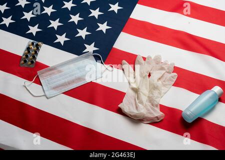antiseptic gloves and mask on the american flag as symbol of quarantine ...