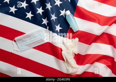 antiseptic gloves and mask on the american flag as symbol of quarantine ...